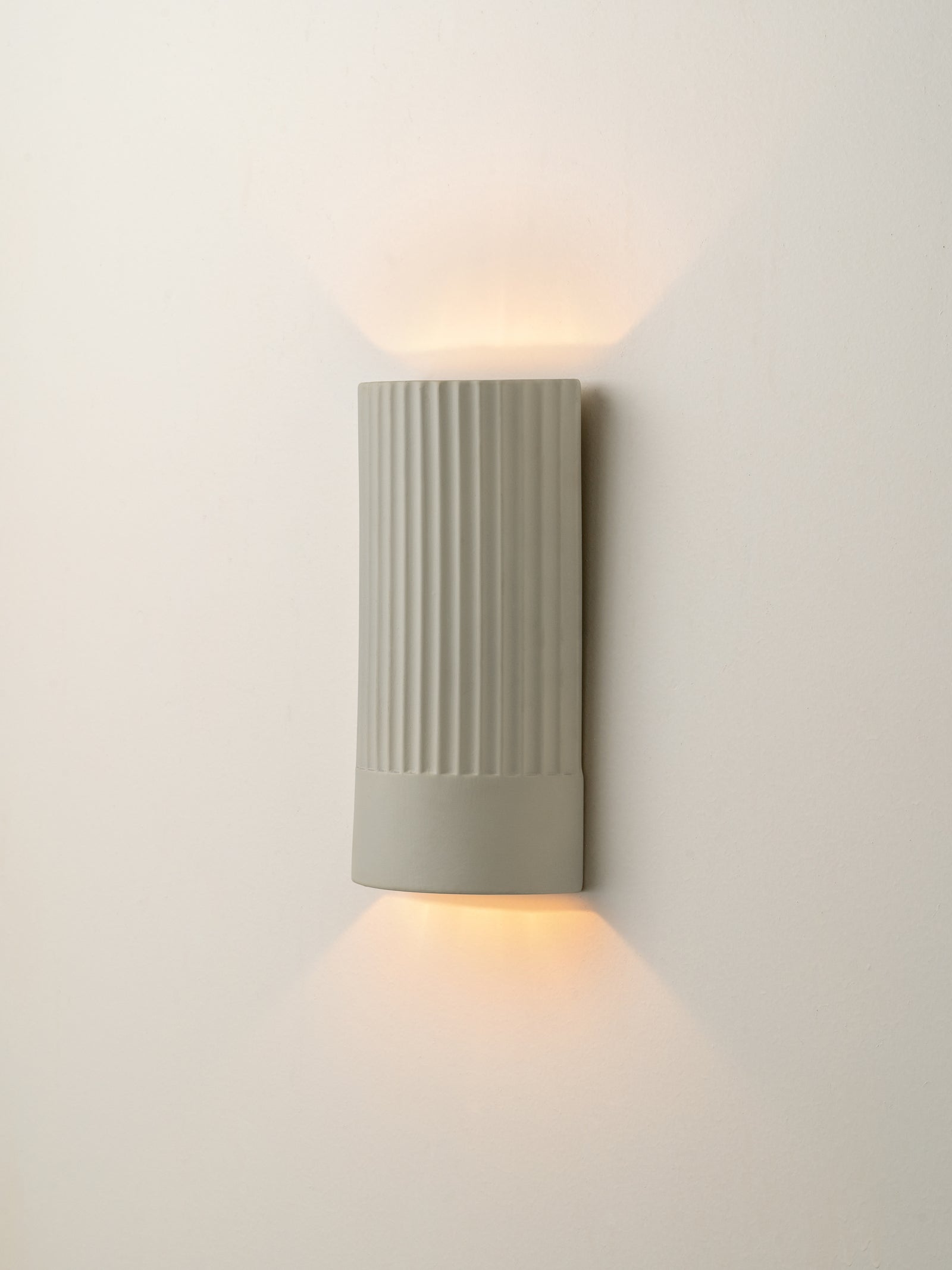 Enza - warm white ribbed ceramic wall light