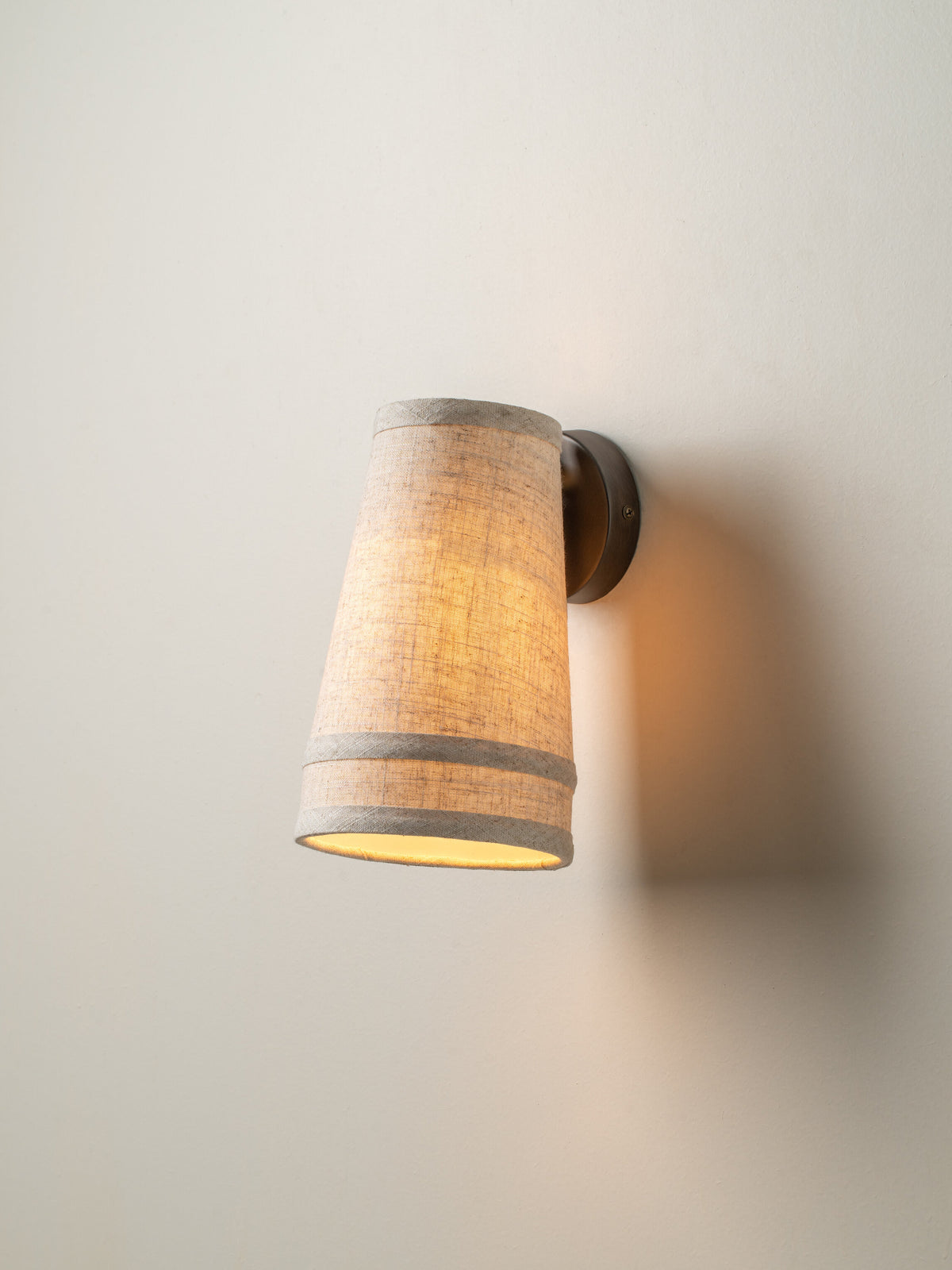Solara - bronze and layered natural linen wall light