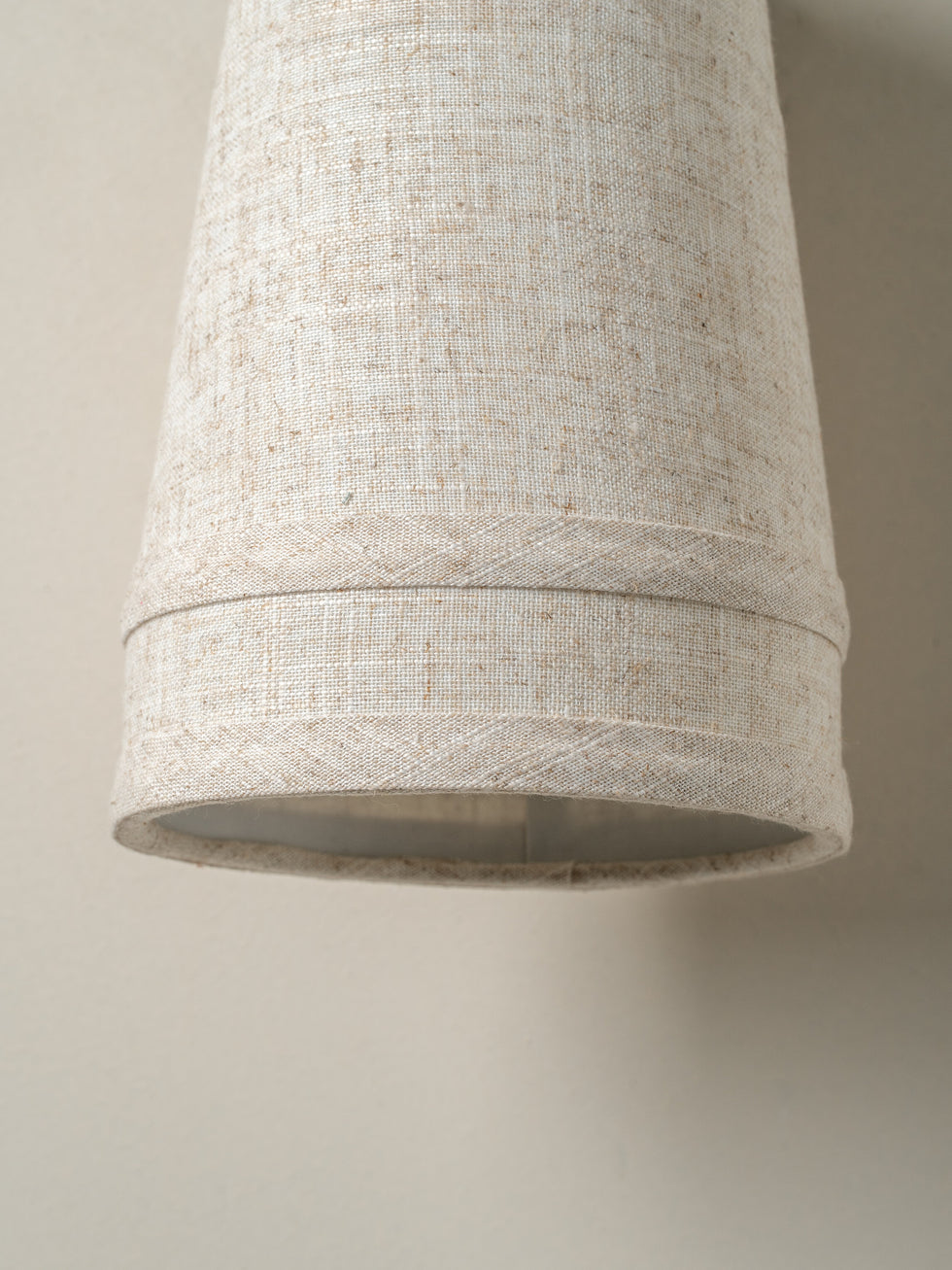 Solara - bronze and layered natural linen wall light